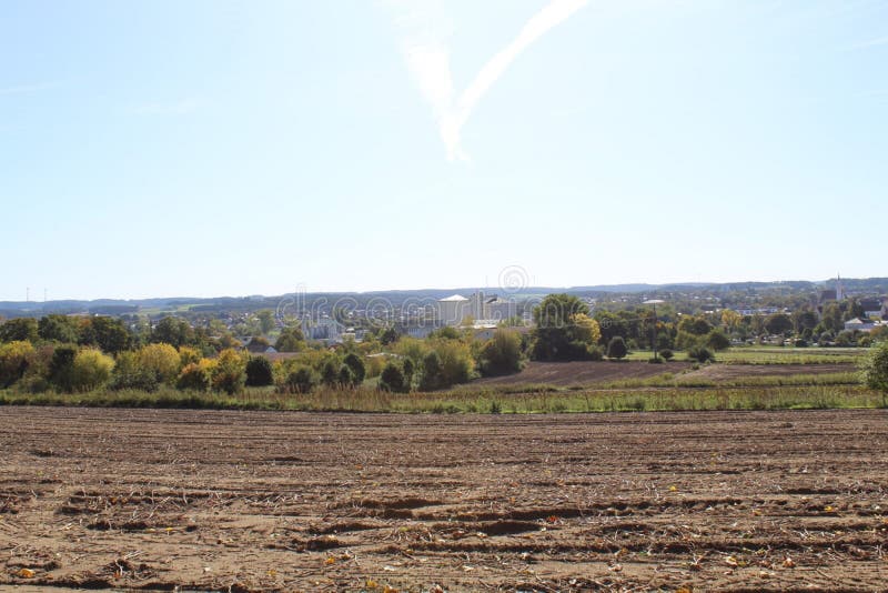 Brown Cropland with Green Trees and a Clear Sky in the Background Stock ...