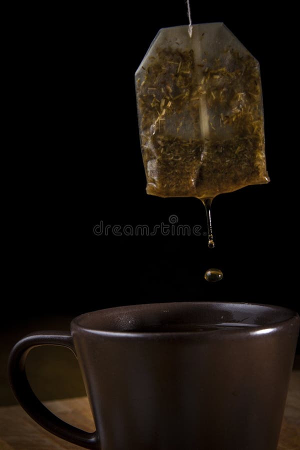 A Brown Cup on a Wooden Mass and on it a Dripping Tea Bag Stock Photo ...