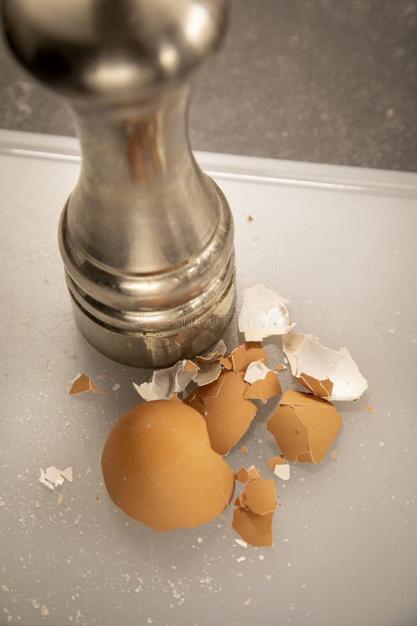 Brown Egg Shells from a Hard Boiled Egg on a White Cutting Board with a ...