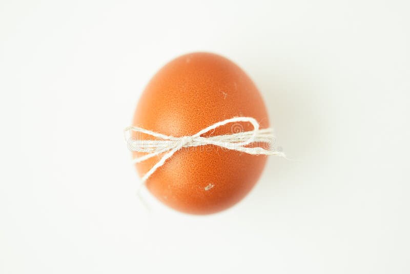 Brown Egg Wrapped with Thread on White Background with Copy Space Stock ...