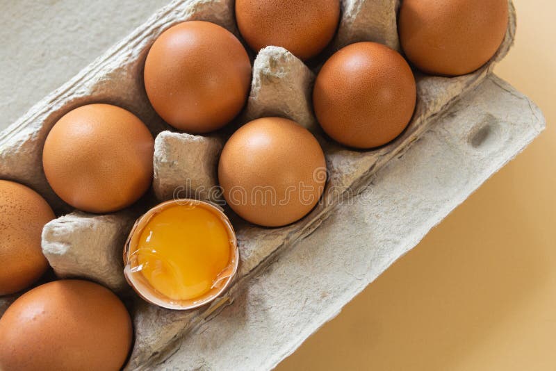 Brown Eggs in a Craft Box. One Egg is Broken Stock Photo - Image of ...