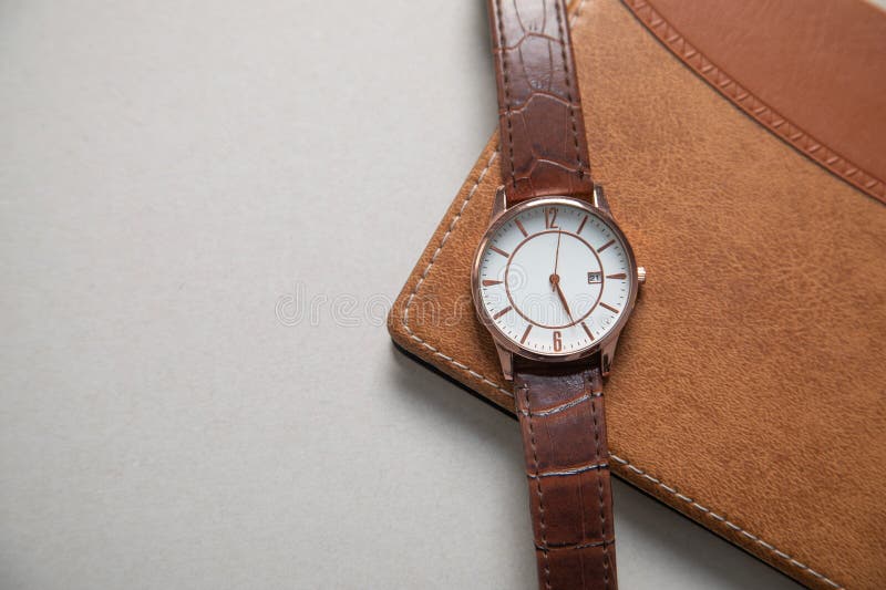 Brown Elegant Wristwatch with a Notepad Stock Photo - Image of finance ...