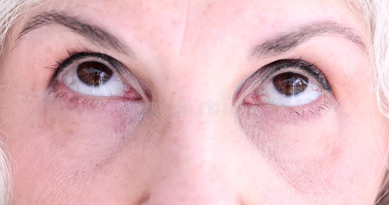 Brown Eyes of Elderly Woman Makes Relaxing Exercise for Eyes Stock ...