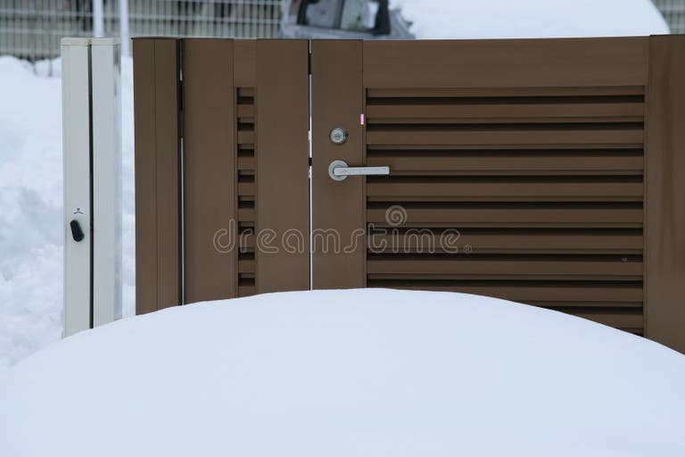 A Brown Gate with Snow in Front of it Stock Photo - Image of urban ...