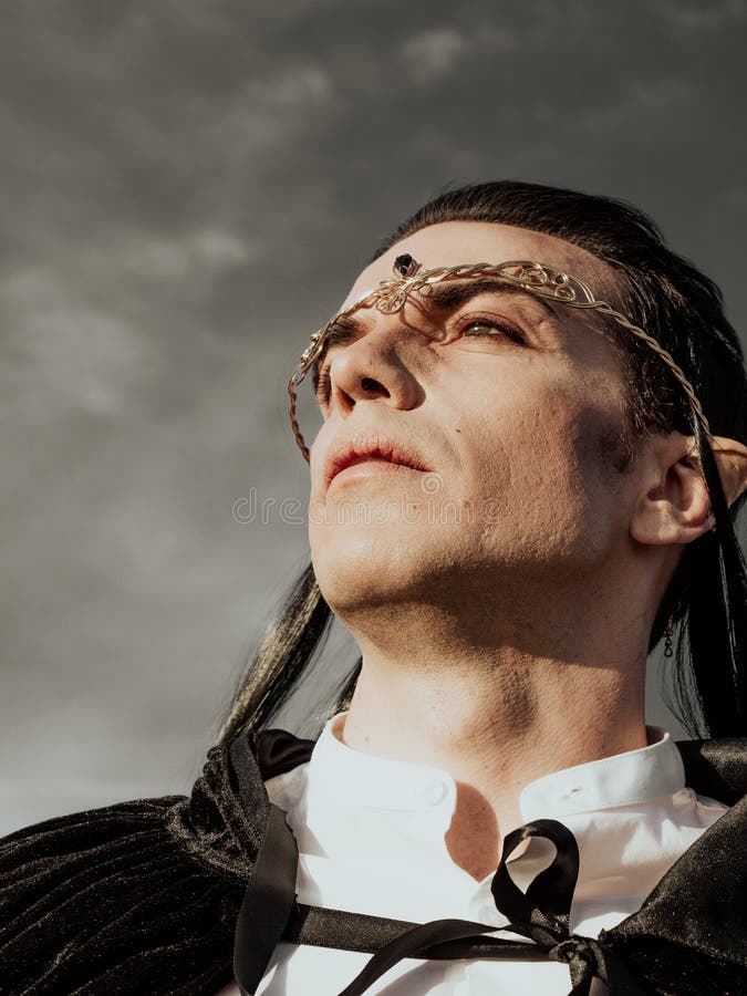 Brown-haired Man with Elf Ears, Tiara on Head and Black Cape, Looks ...