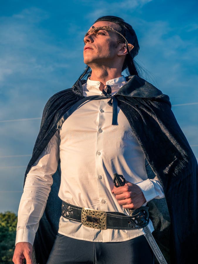 Brown-haired Man with Elf Ears, Tiara on Head and Black Cape, Looks ...