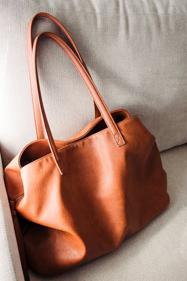 Brown Leather Bag Standing on the Sofa Stock Photo - Image of sofa ...