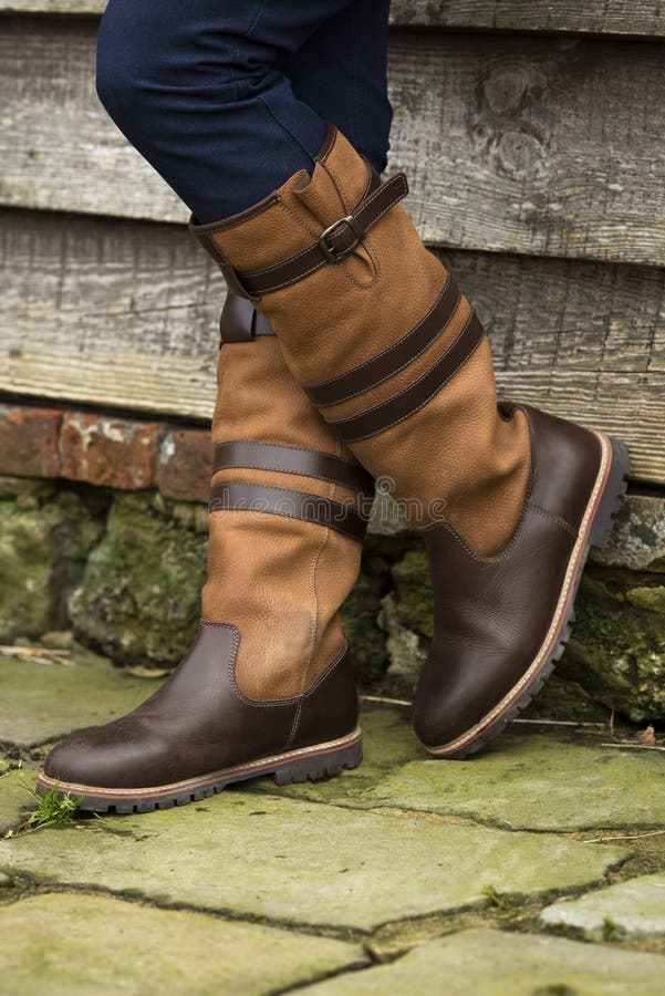 Brown leather boots stock photo. Image of floor, shoes - 221497174