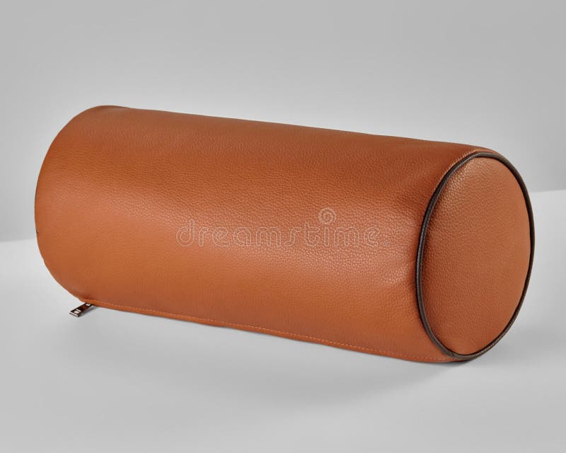 Brown Leather Cylindrical Cushion Resting on White Surface Stock Photo ...