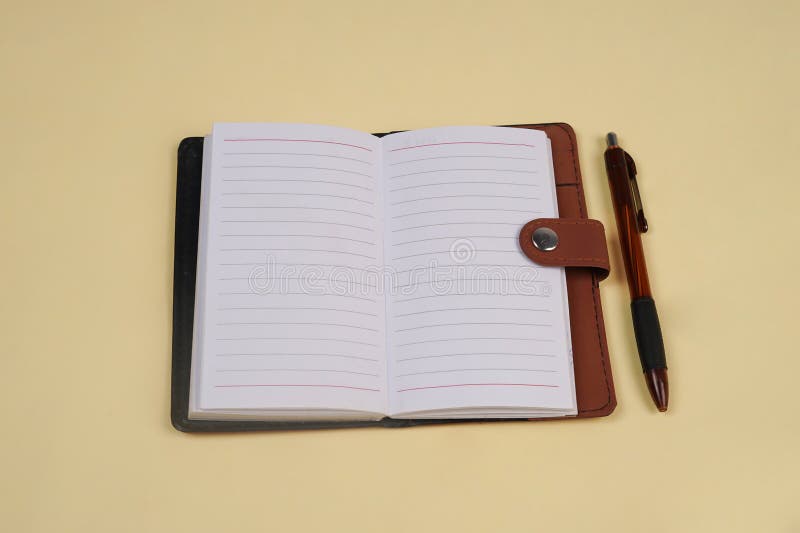 Brown Leather Diary Notebook and Pen Isolated on Yellow Background ...