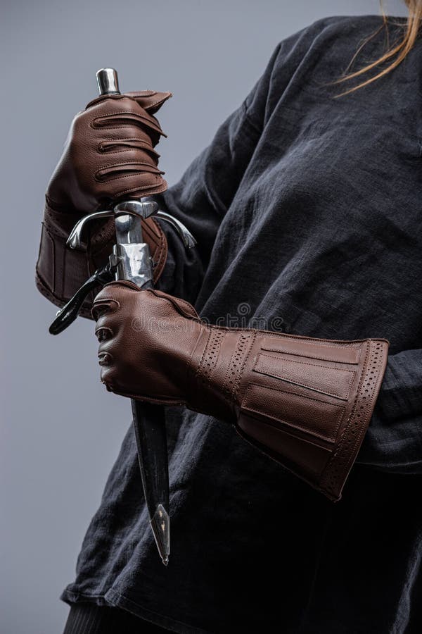 Brown Leather Gauntlets Holding Medieval Sword. Stock Photo - Image of ...