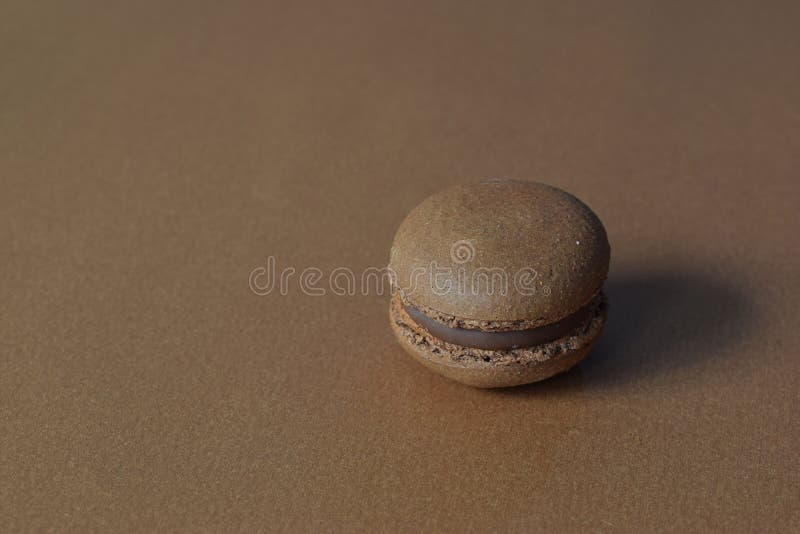 A Brown Macaron on a Minimalistic Brown Background Stock Image - Image ...