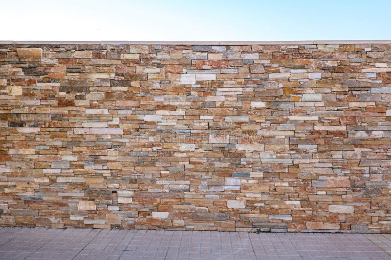 Brown Masonry Fence of Stones, Pavement and Blue Sky. Light Brown Brick ...