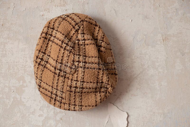 Brown Mens Cap in a Cage Hanging on the White Wall Stock Image - Image ...