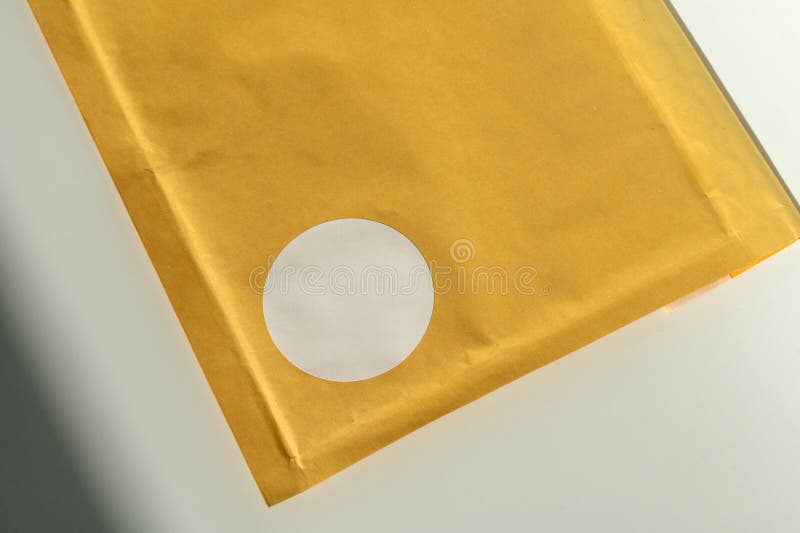 Brown Padded Envelope with White Circular Label on White Surface Stock ...