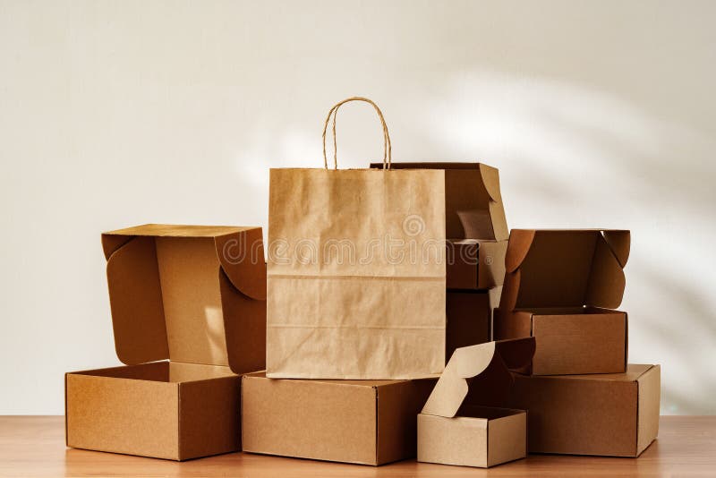 Brown Paper Bag and Cardboard Boxes on a Wooden Surface Stock Image ...
