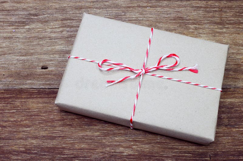Brown Paper Parcel Tied with Red and White String Stock Image - Image ...