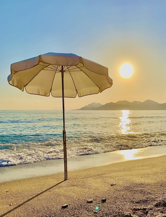 A Single Parasol on a Beach at Sunset Stock Photo - Image of beach ...