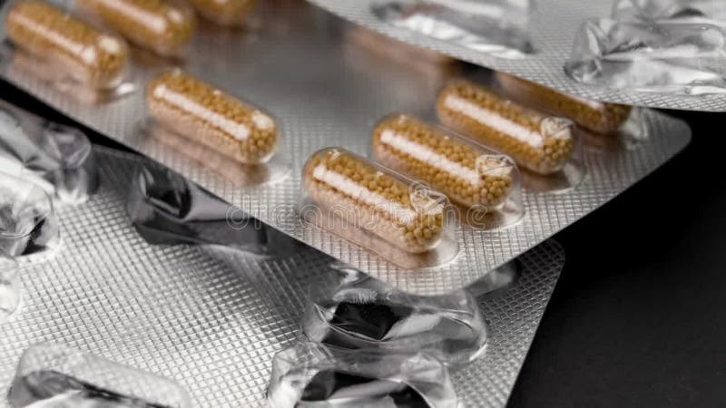 Brown Pharmaceutical Capsules with Particles in a Blister Package Stock ...