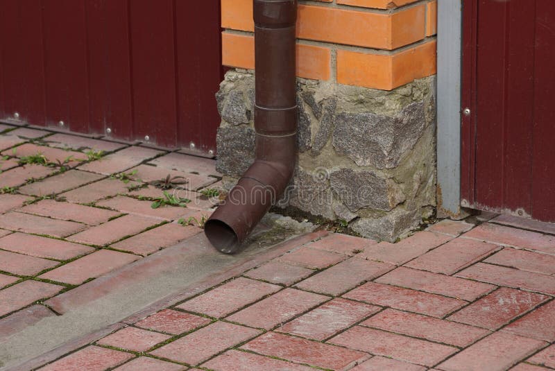 Brown Plastic Gutter Over a Gray Sidewalk Stock Photo - Image of ...