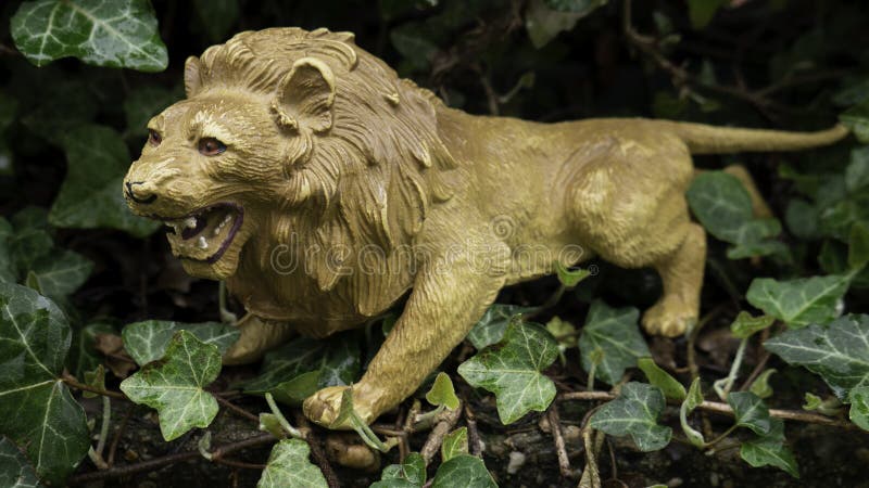 Brown Plastic Toy Lion Outside Stock Image - Image of figure, green ...
