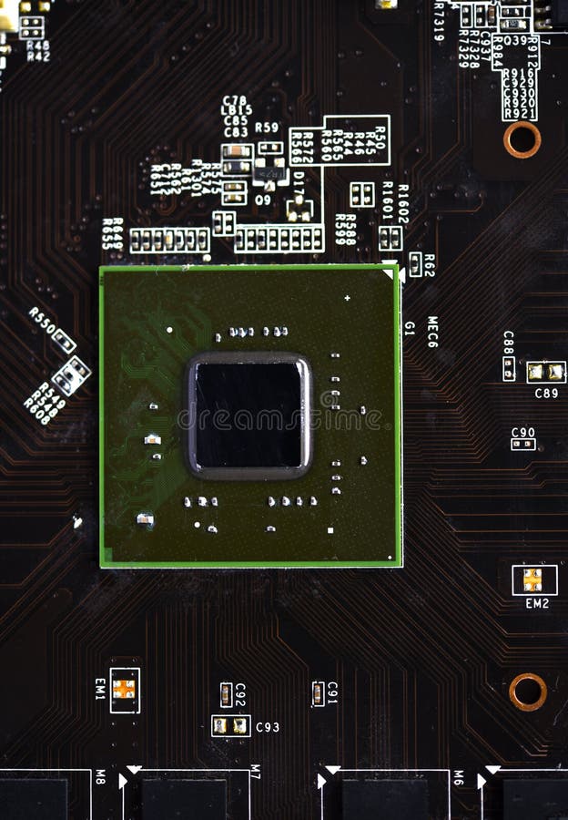 A Brown Printed Circuit Board with a Processor Chip and Video Memory ...