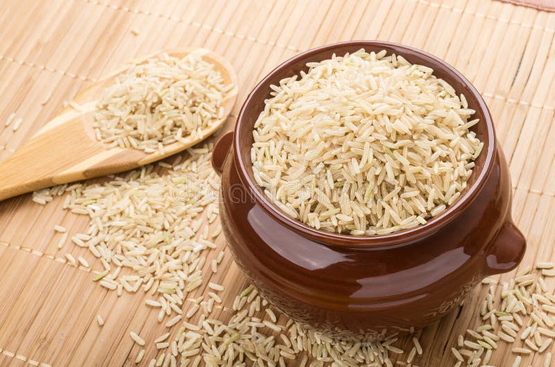 Brown Rice in Ceramic Pot on Bamboo Mat and Spoon Stock Photo - Image ...