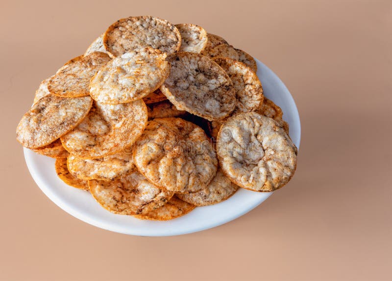 Brown Rice Chips on a White Plate Stock Photo - Image of closeup ...