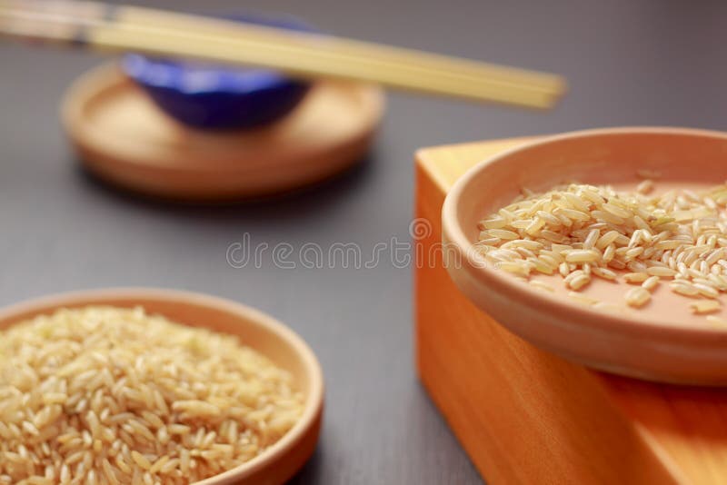 Brown rice on clay plates stock photo. Image of blue - 16399824
