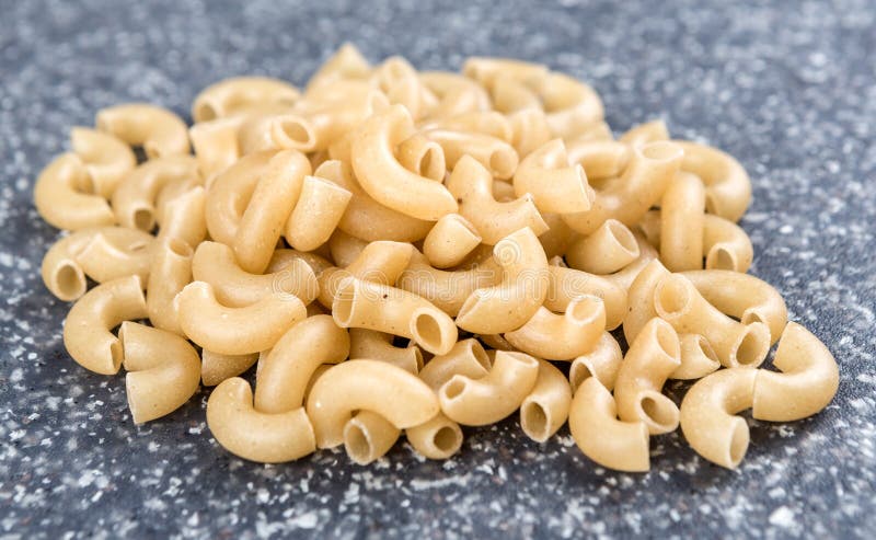 Brown rice elbow macaroni stock image. Image of isolated - 83175269