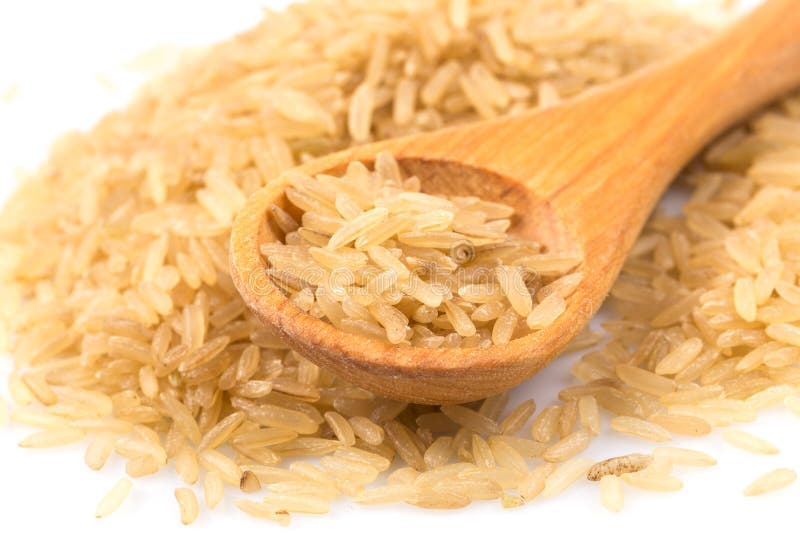 Brown rice over the spoon stock photo. Image of basmati - 49966238