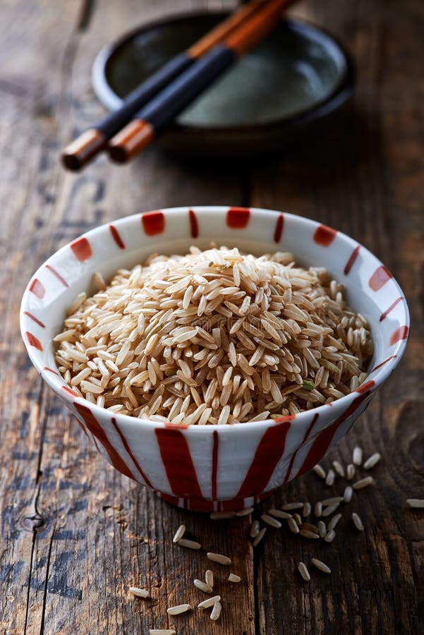 Brown rice in a small bowl stock photo. Image of grain - 30781676
