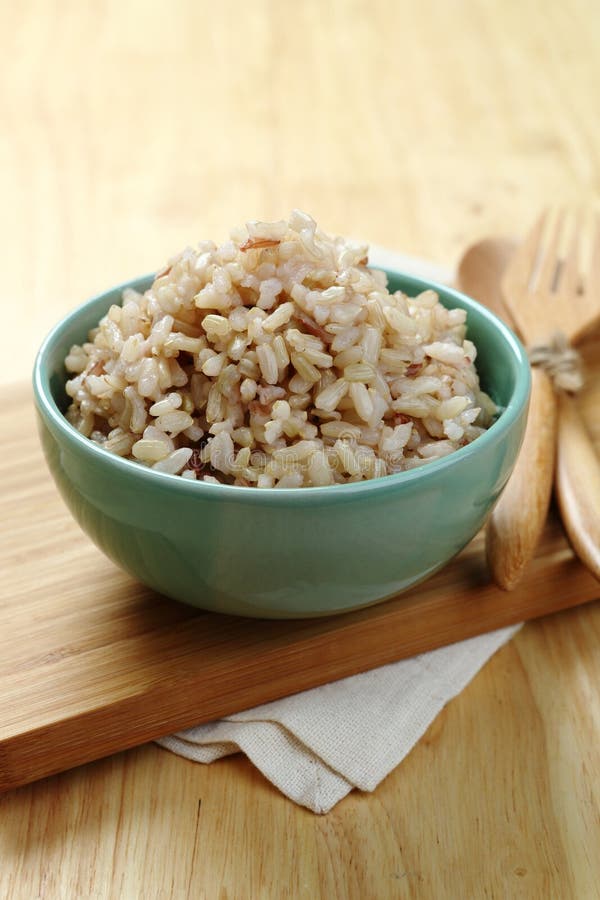 Brown Rice on Wooden Plate stock photo. Image of food - 184419106