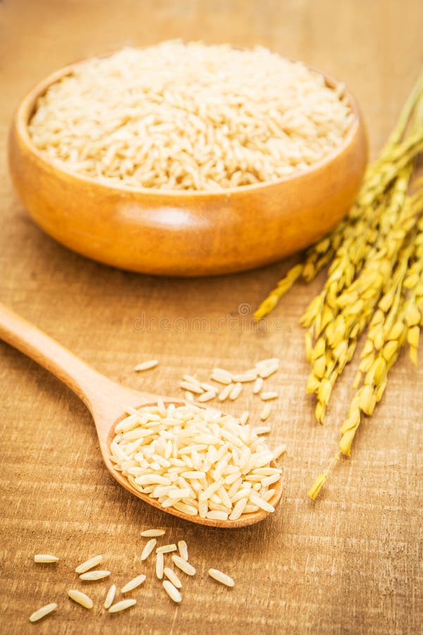 Brown Rice on Wooden Spoon and Bowl Stock Image - Image of desk, seed ...