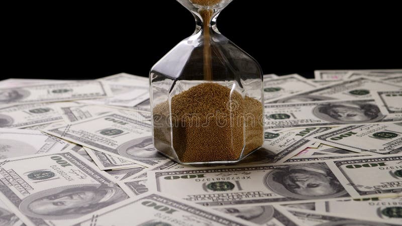 Brown Sand Pouring in Clear Sandglass on Banknotes Stock Image - Image ...