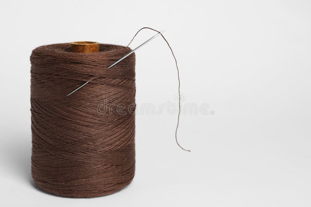 Brown Sewing Thread with Needle on White Background Stock Image - Image ...