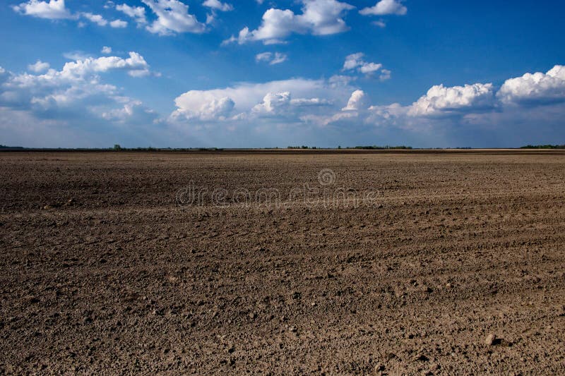 Brown Soil of a Large, Empty Farmland and Clouds Stock Photo - Image of ...