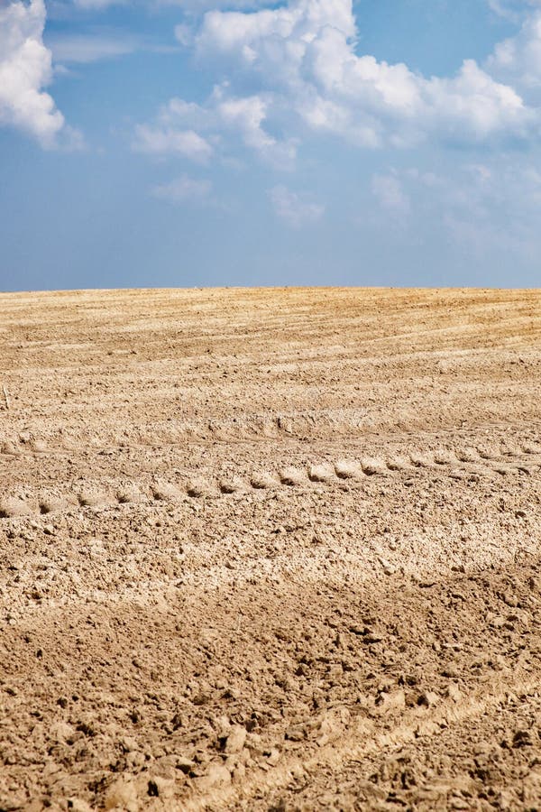 Brown Soil of a Large, Empty Farmland and Clouds Stock Image - Image of ...
