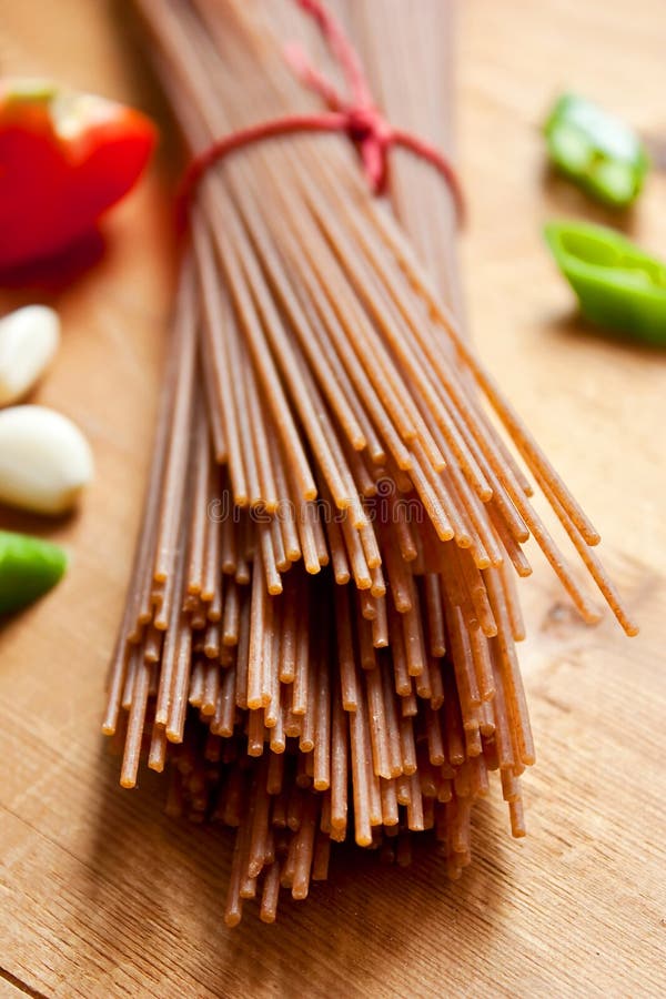 Brown spelt spaghetti stock image. Image of wooden, pepper - 16062363