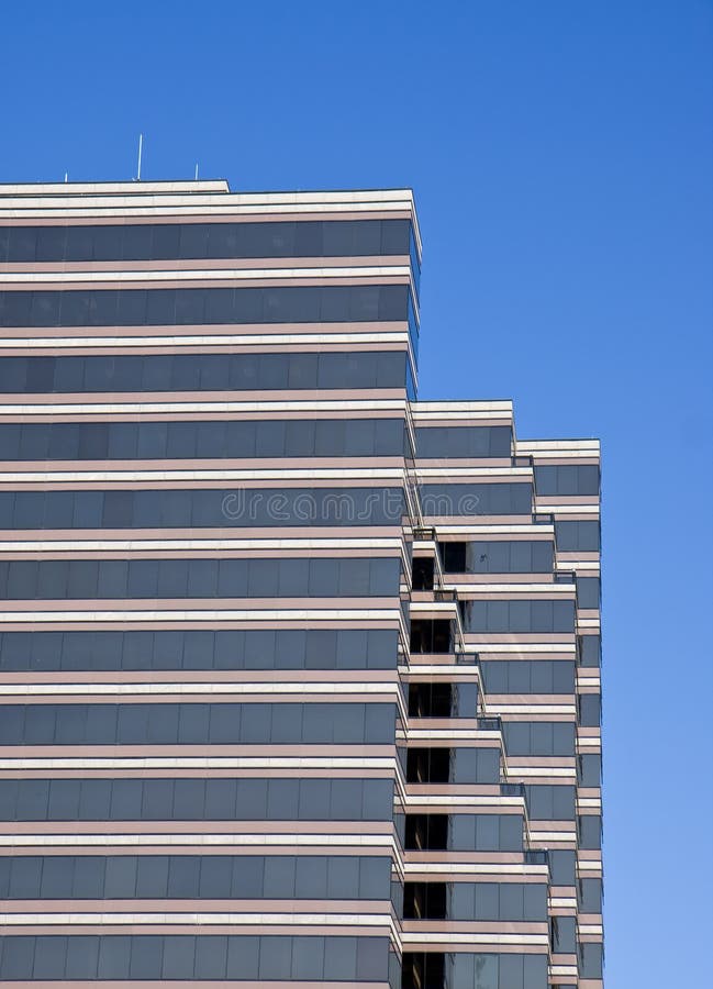 Brown Striped Glass Tiered Building on Blue Stock Image - Image of ...