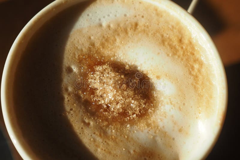 Brown Sugar Pouring from a in a Paper Packet on a Coffee Cup Stock ...