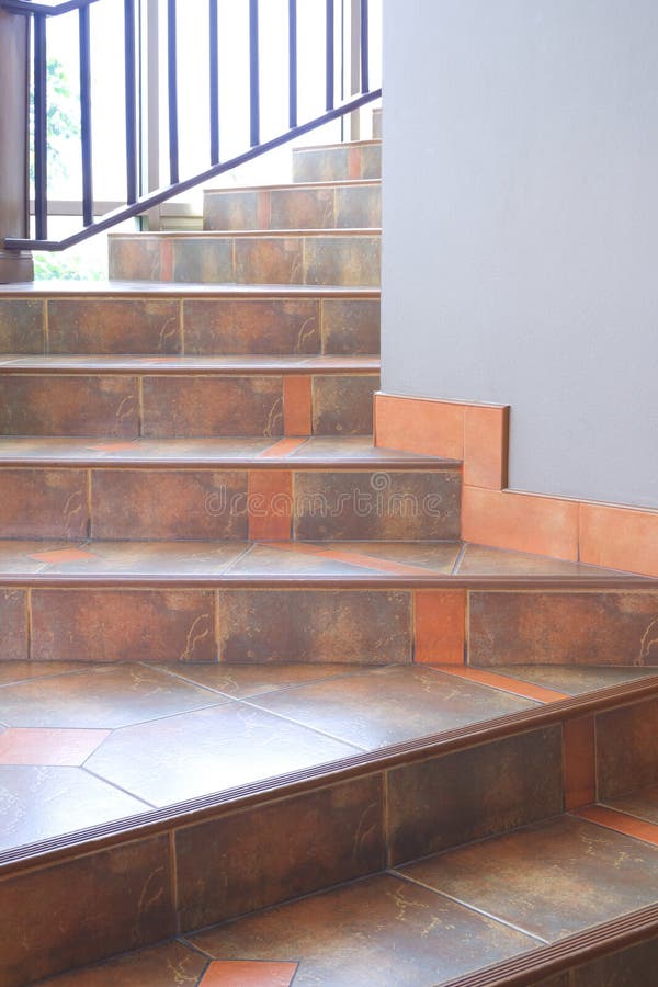 Brown Tile Steps of Interior Spiral Staircase with Steel Balustrade ...
