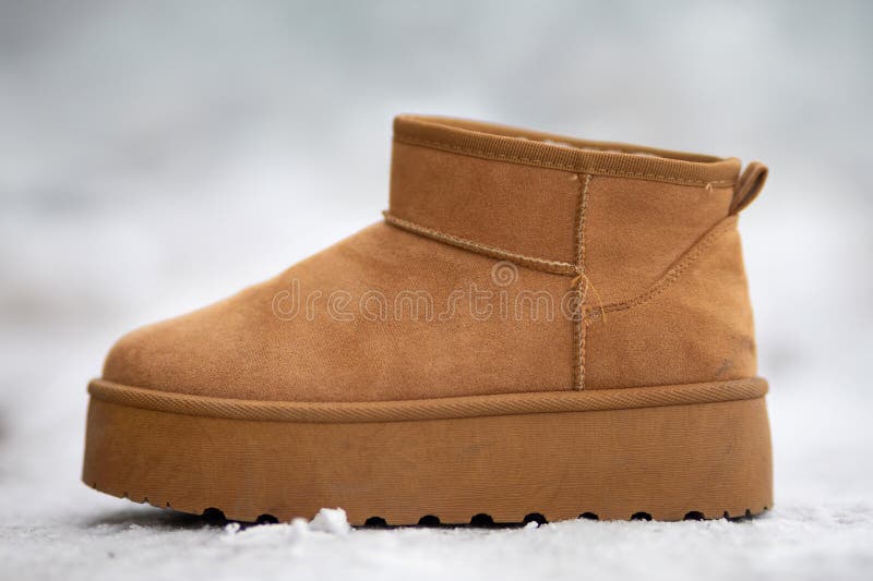 Brown Ugg Classic Mini Platform Weather Boot in the Snow Stock Image ...