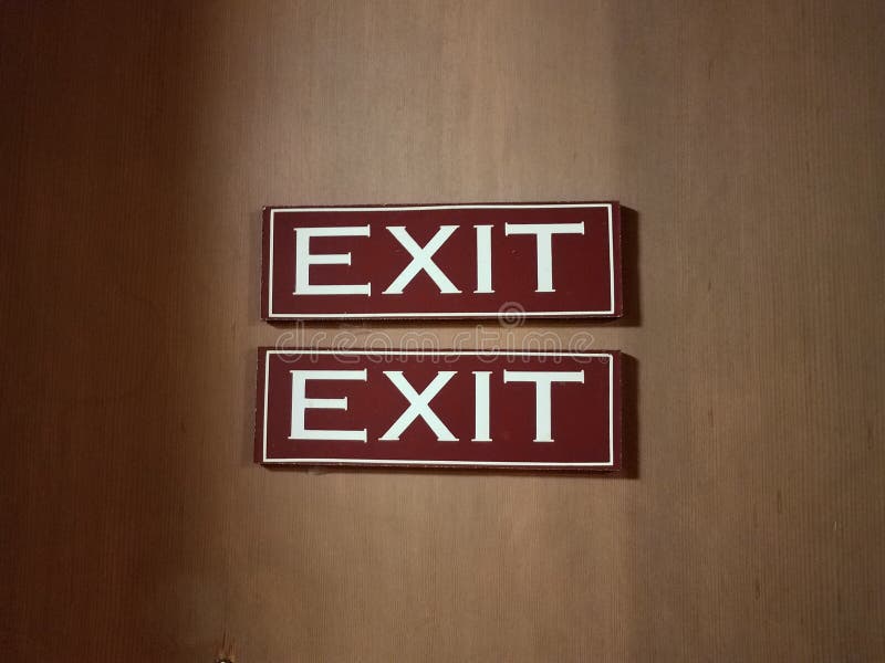 Brown and White Double Exit Sign on Wall Stock Photo - Image of exit ...
