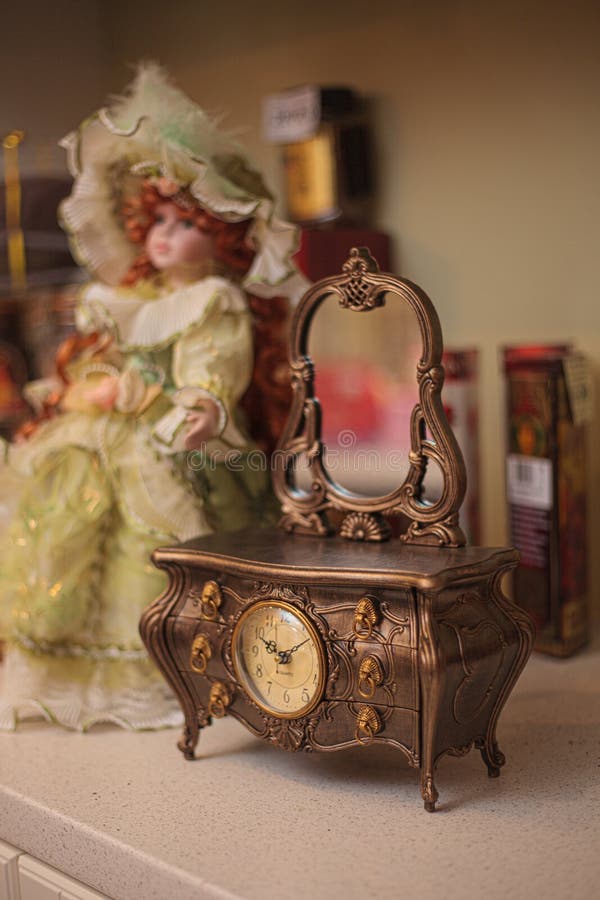 Brown Wooden Casket - Clock on the Shelf with a Doll Stock Image ...