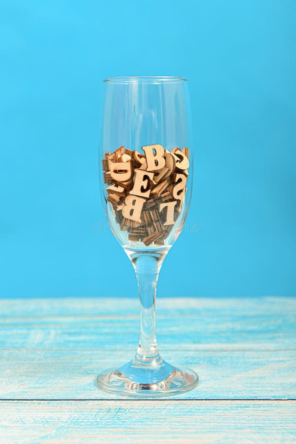 Brown Wooden Letters in a Champagne Glass Stock Photo - Image of ...