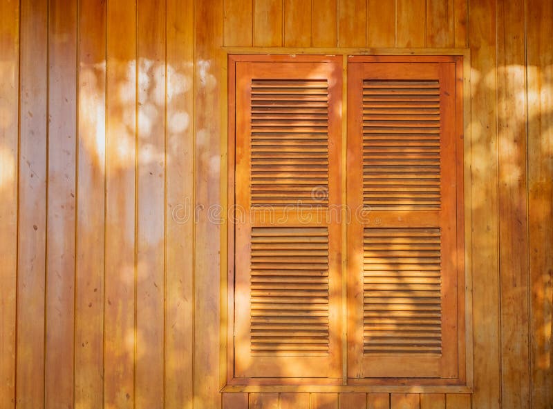 Brown Wooden Shutters on a Wooden Wall Background Stock Image - Image ...