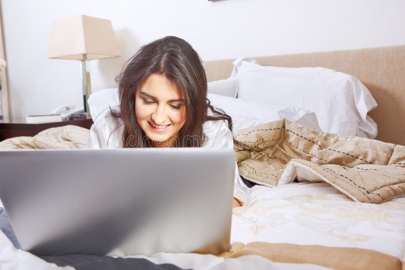 Browsing internet on bed stock photo. Image of bedroom - 28671830