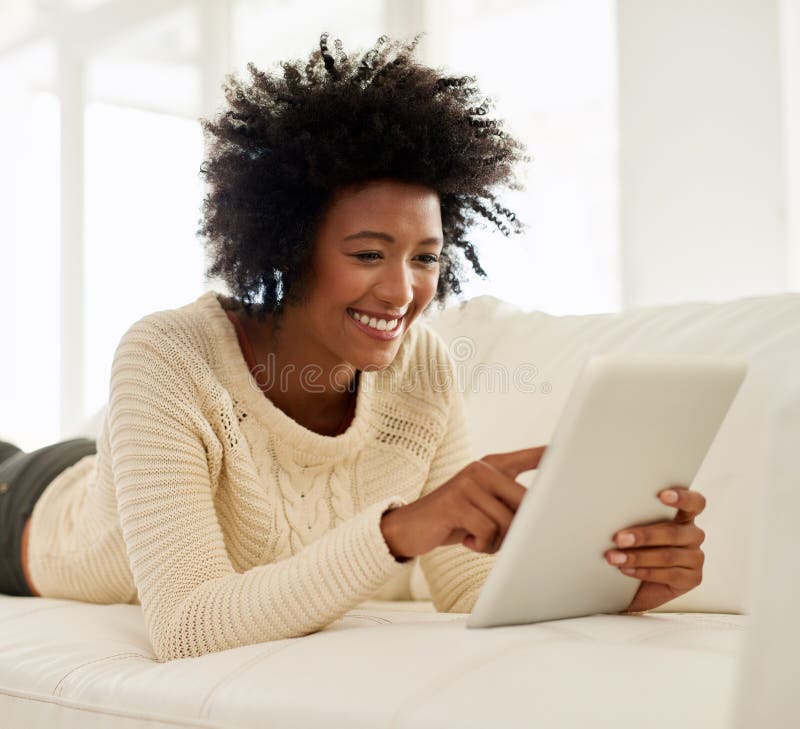 Browsing the Latest Blogs. an Attractive Young Using Her Tablet while ...