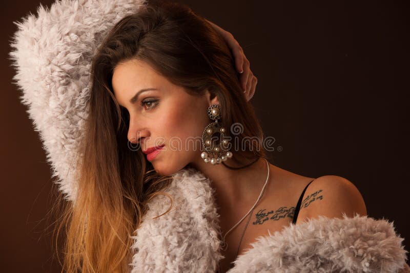Brunette Dancer Posing in a White Fluffy Coat in Front of Dark ...
